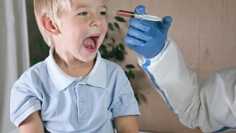 Kid getting polio drops. Doctor making t... | Stock Video | Pond5
