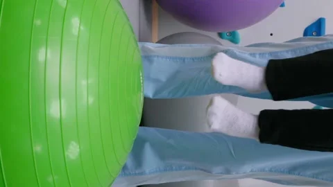 Kid legs jumping on ball on sensory inte... | Stock Video | Pond5