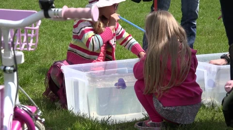 Kid play duck race game in water pool wi... | Stock Video | Pond5