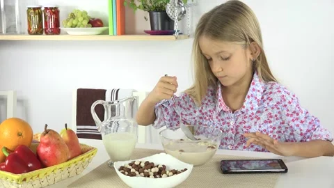 Kid Playing Tablet, Child Eating Cereals... | Stock Video | Pond5