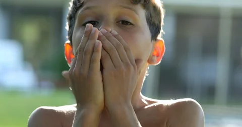 Kid putting hand in mouth in amazement. ... | Stock Video | Pond5