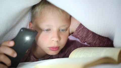 Kid reading paper book with interest lay... | Stock Video | Pond5