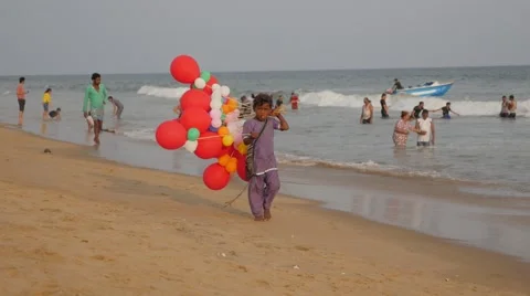 Kid selling balloons on the beach,Puri,I... | Stock Video | Pond5