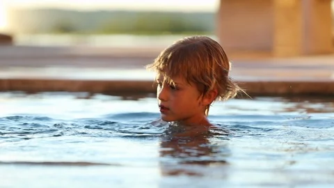 Kid at the swimming pool little boy play... | Stock Video | Pond5