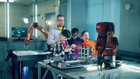 Kids and their instructor work with robo... | Stock Video | Pond5