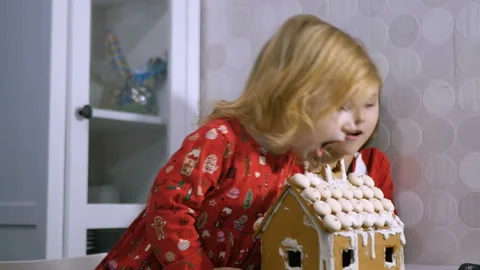 Kids eating an gingerbread house, two li... | Stock Video | Pond5