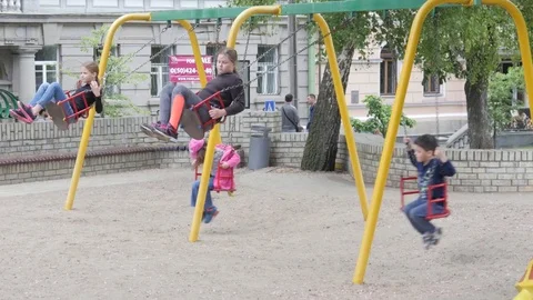Kids enjoy swaying on swing and have fun... | Stock Video | Pond5