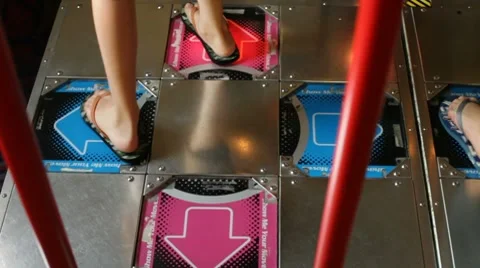 Kids feet playing dancing arcade game | Stock Video | Pond5