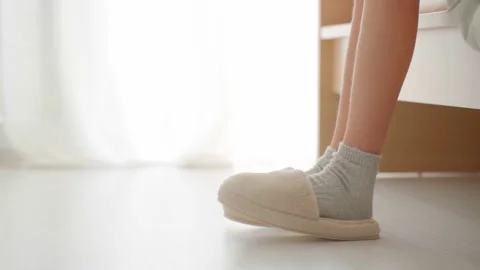Kid's feet putting slippers on. The chil... | Stock Video | Pond5