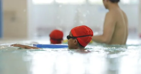 Kids having fun at indoor swimming pool | Stock Video | Pond5