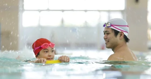 Kids having fun at indoor swimming pool | Stock Video | Pond5