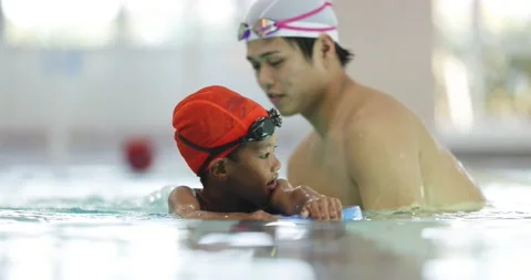 Kids having fun at indoor swimming pool | Stock Video | Pond5