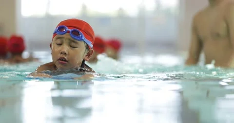 Kids having fun at indoor swimming pool | Stock Video | Pond5