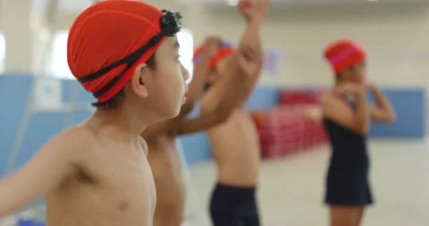Kids having fun at indoor swimming pool | Stock Video | Pond5