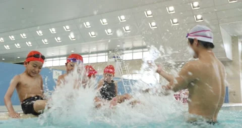 Kids having fun at indoor swimming pool | Stock Video | Pond5