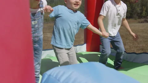Kids Hold Hands While Jumping On Bounce ... | Stock Video | Pond5