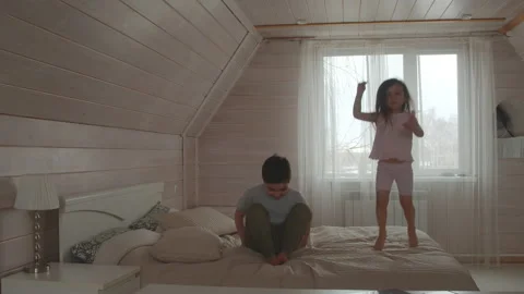 Kids jumping on bed. Having fun together... | Stock Video | Pond5