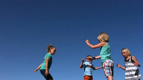 Kids jumping on trampoline, slow motion | Stock Video | Pond5