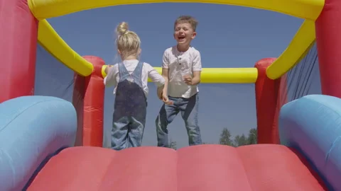 Kids Laugh Jumping On Bounce House | Stock Video | Pond5