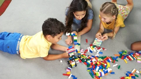 Kids laying on the floor and playing wit... | Stock Video | Pond5