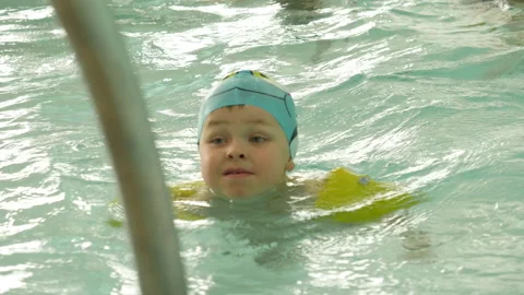 Kids learning to swim in swimming pool a... | Stock Video | Pond5