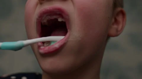 Kid's mouth brushing teeth close up. | Stock Video | Pond5