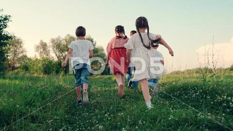 Kids , parents run in park, friends play in summer. Family, mom, dad ...