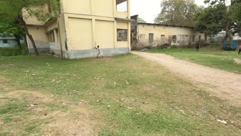 kids playing cricket in backyard of scho... | Stock Video | Pond5