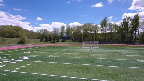 KIDS PLAYING ON A FOOTBALL FIELD | Stock Video | Pond5