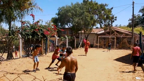 kids playing football at sand field | Stock Video | Pond5