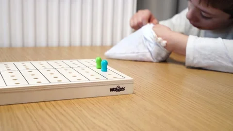 Kids playing Mastermind wooden game of t... | Stock Video | Pond5