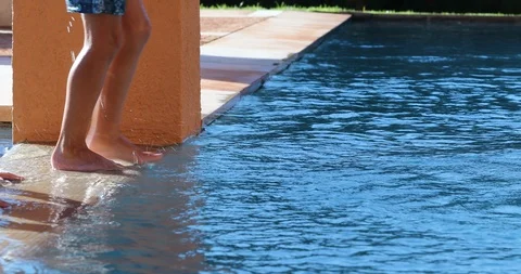 Kids playing at the swimming pool diving... | Stock Video | Pond5