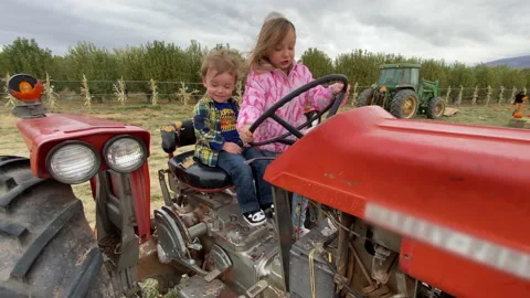 Kids Playing on a Tractor | Stock Video | Pond5
