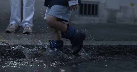 Kid's Rainboot Steps Sending Water Splas... | Stock Video | Pond5