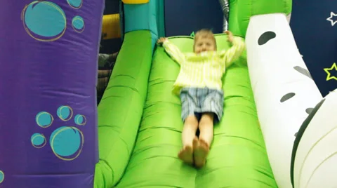 kids sliding down an inflatable Side | Stock Video | Pond5