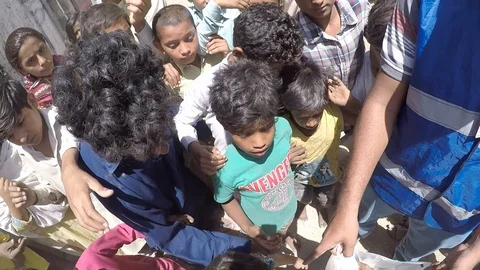 Kids snatch food packets from each other... | Stock Video | Pond5