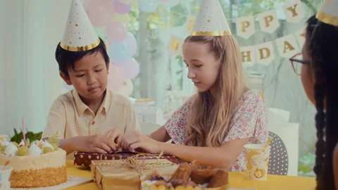 Kids Trying to Unpack Birthday Present a... | Stock Video | Pond5