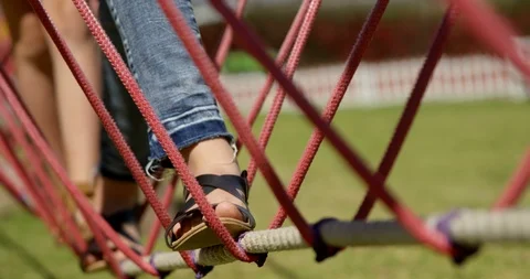 Kids walking on a rope bridge in the gar... | Stock Video | Pond5