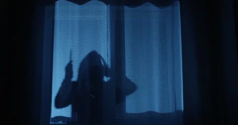 Killer is Looking through the Window at ... | Stock Video | Pond5