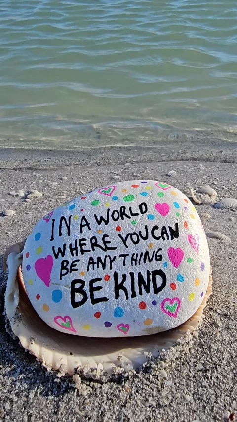Kindness rock with be kind message on se... | Stock Video | Pond5
