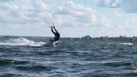 Kiteboarder jumping the waves | Stock Video | Pond5