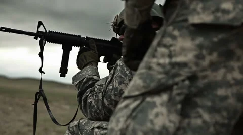 Kneeling soldier shoots M4 rifle in targ... | Stock Video | Pond5