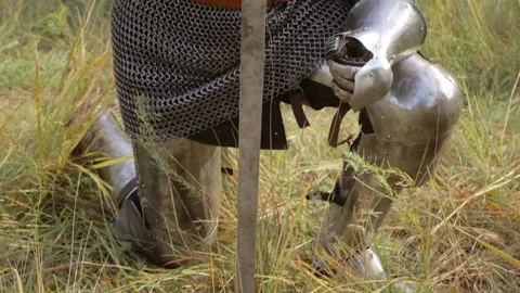 knight sticks a two-handed sword into th... | Stock Video | Pond5
