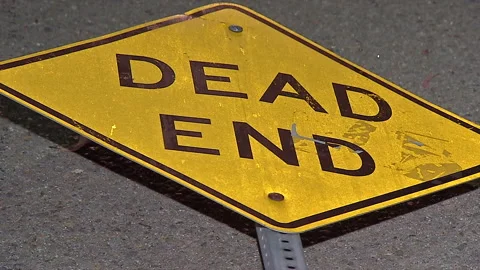 Knocked over Dead End sign on the ground... | Stock Video | Pond5