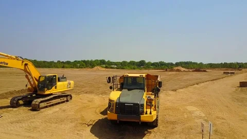 Komatsu Hydraulic Excavator and Dump Tru... | Stock Video | Pond5