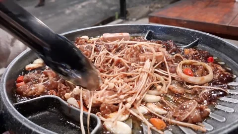 Korean BBQ Grill Loaded with Enoki Mushr... | Stock Video | Pond5
