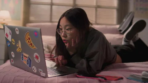 Korean Girl Using Laptop Lying on Bed in... | Stock Video | Pond5