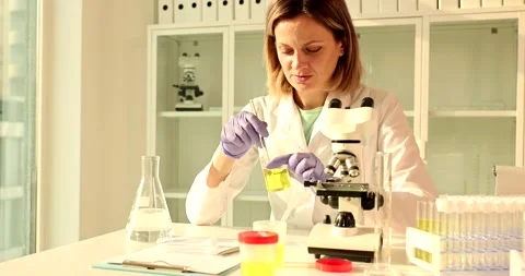 Lab worker stirs patient urine sample to... | Stock Video | Pond5