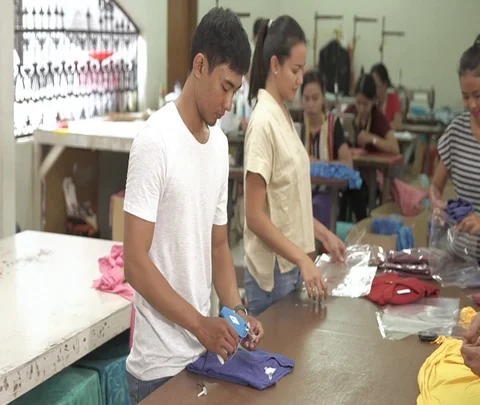 labelling and packaging process in garme... | Stock Video | Pond5