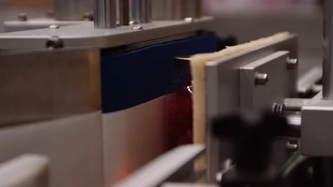 Labelling machine puts label on bottles ... | Stock Video | Pond5
